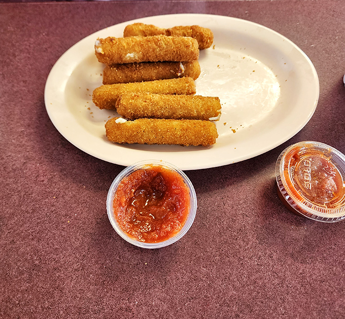 Golden-brown mozzarella sticks stand at attention, ready to stretch into that perfect cheese pull that makes everyone at the table jealous.