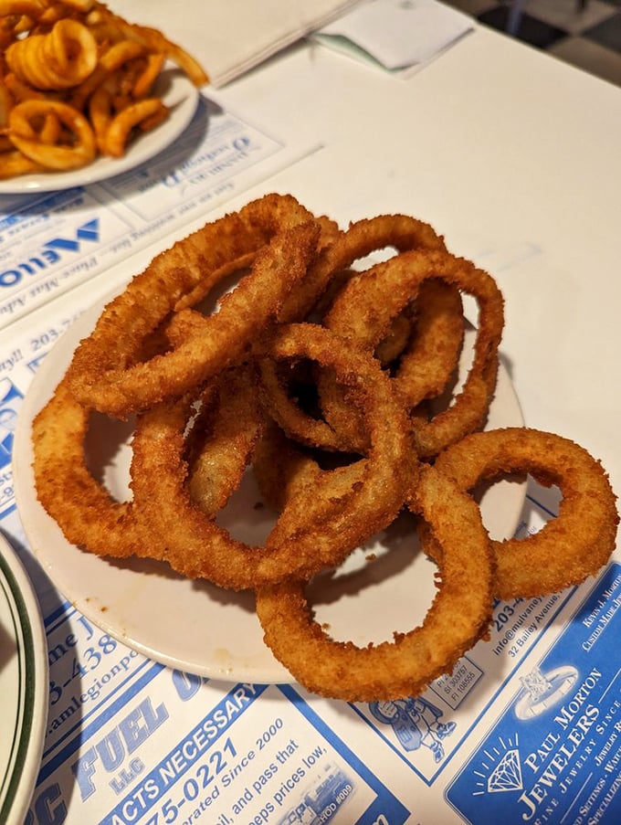These golden-brown onion rings aren't just a side&mdash;they're crispy, hand-breaded halos of happiness demanding their moment in the spotlight.