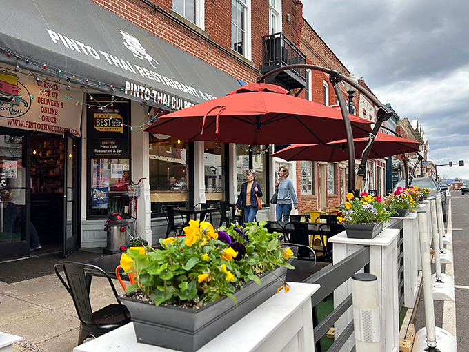 PINTO Thai's outdoor seating area blooms with both flowers and conversation. The bright umbrellas are like exclamation points punctuating delicious sentences of spicy curries and noodles.