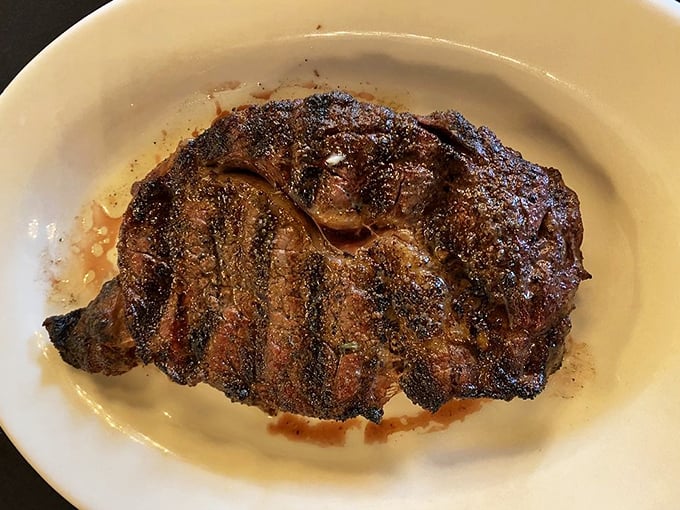 A prime rib that's dressed for success with that perfect pink center. This isn't just meat; it's a masterpiece with grill marks.