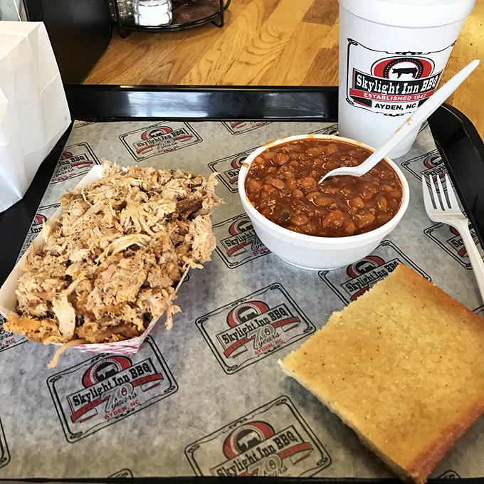 The barbecue trifecta&mdash;chopped pork, cornbread, and beans&mdash;arranged on a tray that's seen thousands of satisfied smiles over the decades.