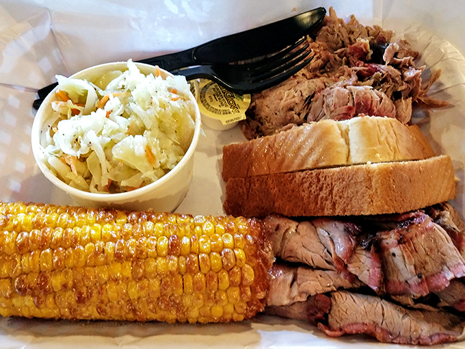 A barbecue triple threat: Juicy pulled pork, pink-ringed brisket slices, and corn still sweet enough to remember summer. The coleslaw offers a crisp respite.