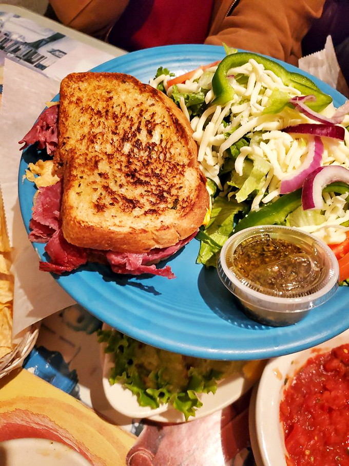 This isn't just a sandwich; it's a tower of pastrami possibility served with a side of coleslaw that's having its own little flavor party.