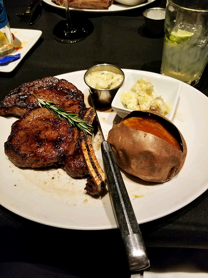 The bone-in ribeye arrives with that quintessential crosshatch sear that says, "A professional who respects beef prepared me." Paired with a loaded potato that's practically architectural.