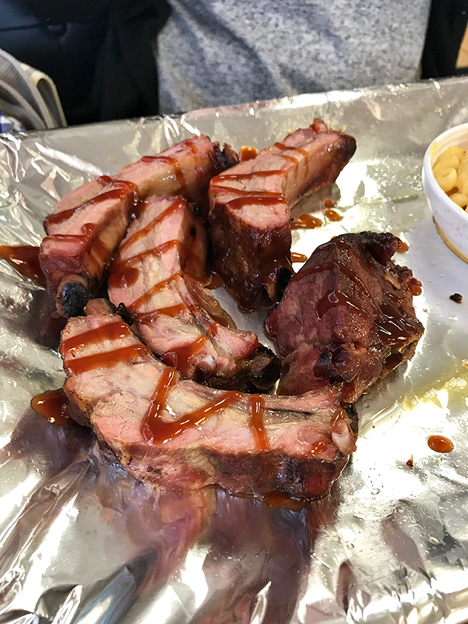 These ribs aren't falling off the bone&mdash;and that's exactly right. The pink smoke ring and glistening sauce tell you everything about the pitmaster's skill.