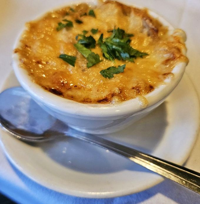 Behold the bubbling crown of Gruy&egrave;re that transforms simple soup into a religious experience. Spoon-to-mouth distance has never felt so long. 