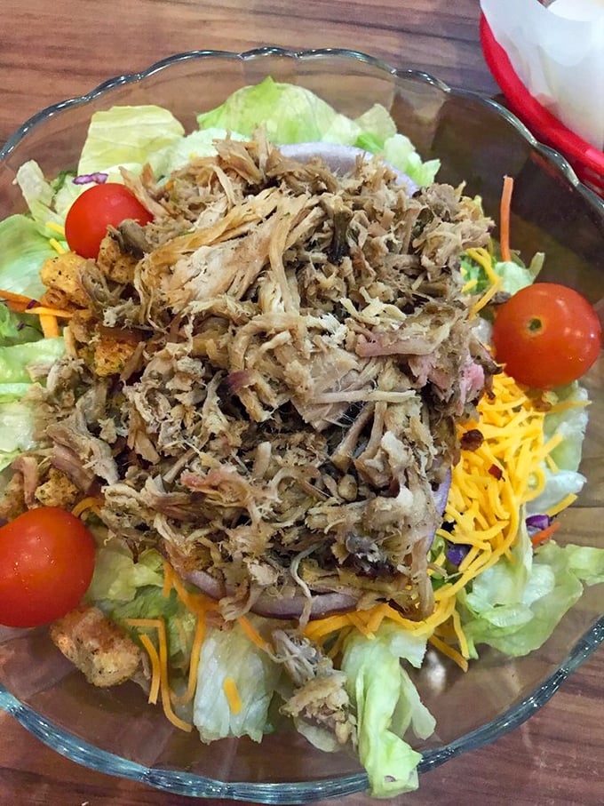 Garden salad gets the VIP treatment with a crown of pulled pork. Who says eating your greens can't be indulgent?
