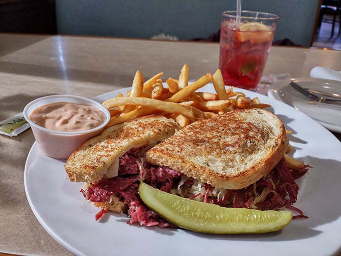 The Reuben sandwich that launched a thousand cravings &ndash; perfect corned beef nestled between golden bread with a pickle standing guard.