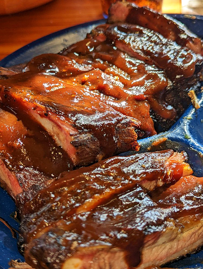 Glistening with sauce and sporting that telltale smoke ring, these ribs aren't just dinner—they're edible proof that good things come to those who wait.