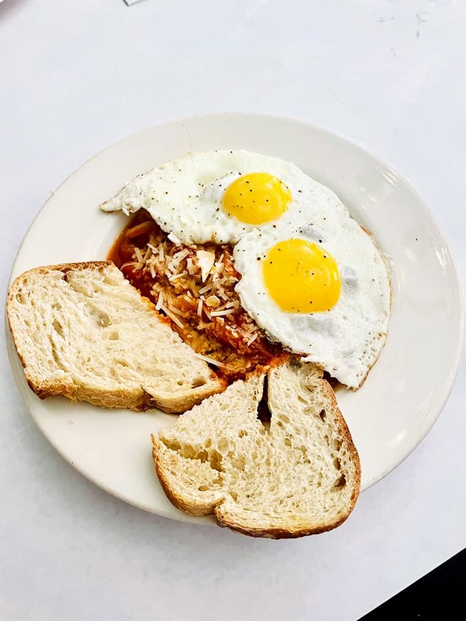 Two sunny-side eggs keeping watch over a kingdom of toast and hash&mdash;breakfast doesn't get more royally satisfying than this.