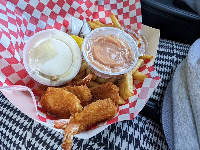 Golden-fried shrimp nestled against crispy fries&mdash;proof that sometimes the simplest pleasures come in red-and-white checkered paper.
