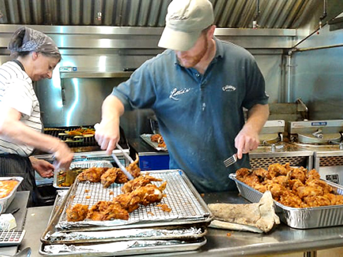 The kitchen maestros at work, orchestrating a symphony of crispy chicken. These are the unsung heroes your taste buds will thank profusely.
