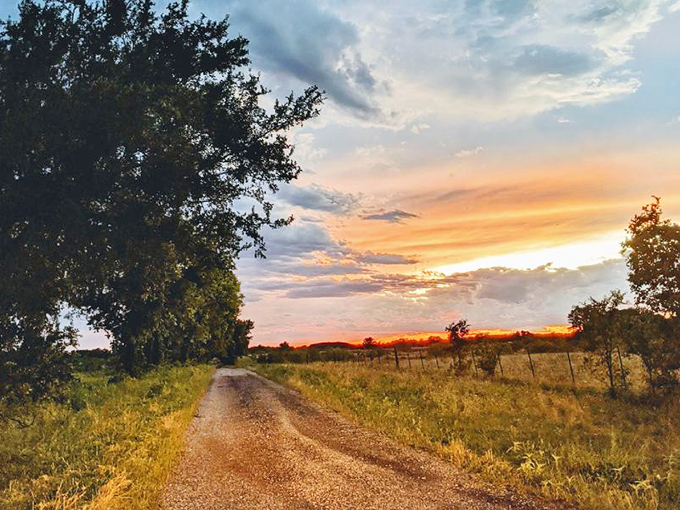 Country roads take you home—or at least to spectacular Texas sunsets that paint the sky in hues no Instagram filter could improve upon.