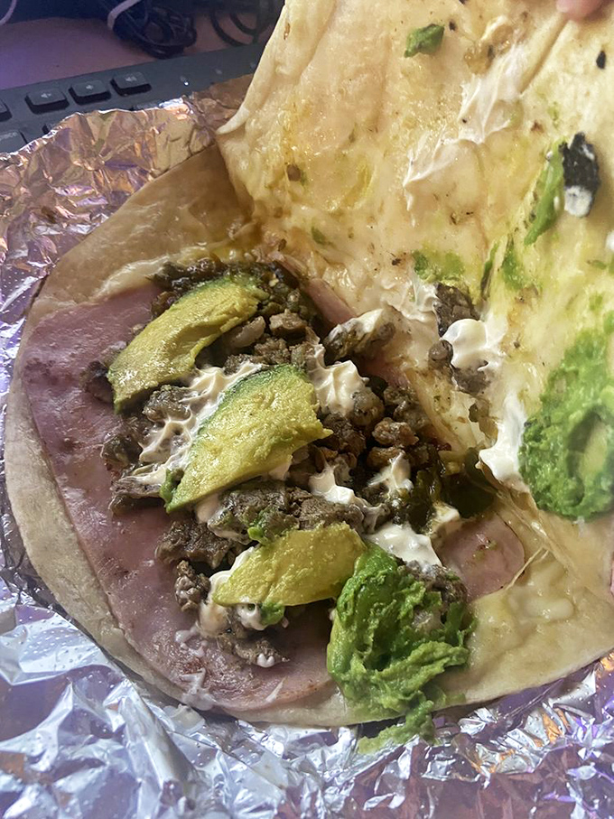 Avocado slices peeking out like they know something you don't. That secret? You're about to experience flavor combinations that'll haunt your dreams.