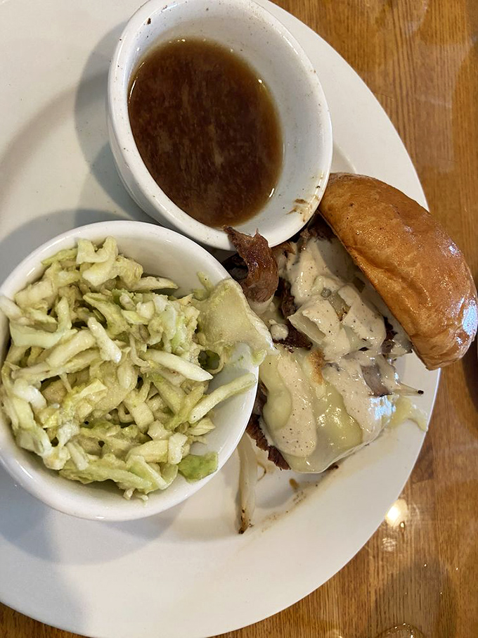 This sandwich isn't just a meal, it's an event. The slaw provides the perfect crisp counterpoint to what appears to be a seriously indulgent creation.