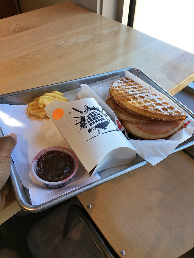 The Monte Cristo arrives like royalty on a metal throne. Powdered sugar dusting adds that "I'm fancy but approachable" vibe.