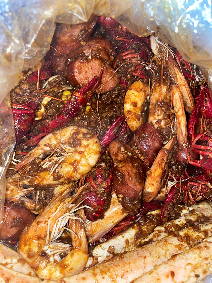 "The Ultimate" isn't just a name &ndash; it's a seafood summit meeting where crawfish, shrimp, and sausage negotiate deliciously in spiced butter diplomacy.