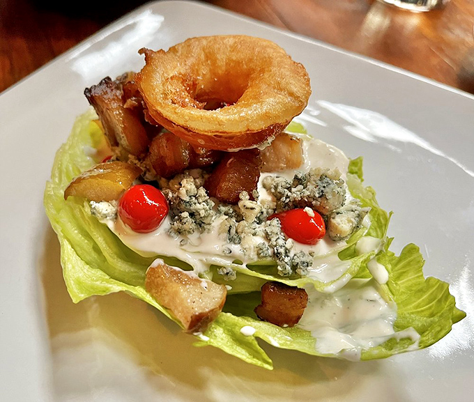 The wedge salad reimagined: crisp lettuce, blue cheese, and that magnificent onion ring crown. Salad wearing a royal hat is my kind of greens.