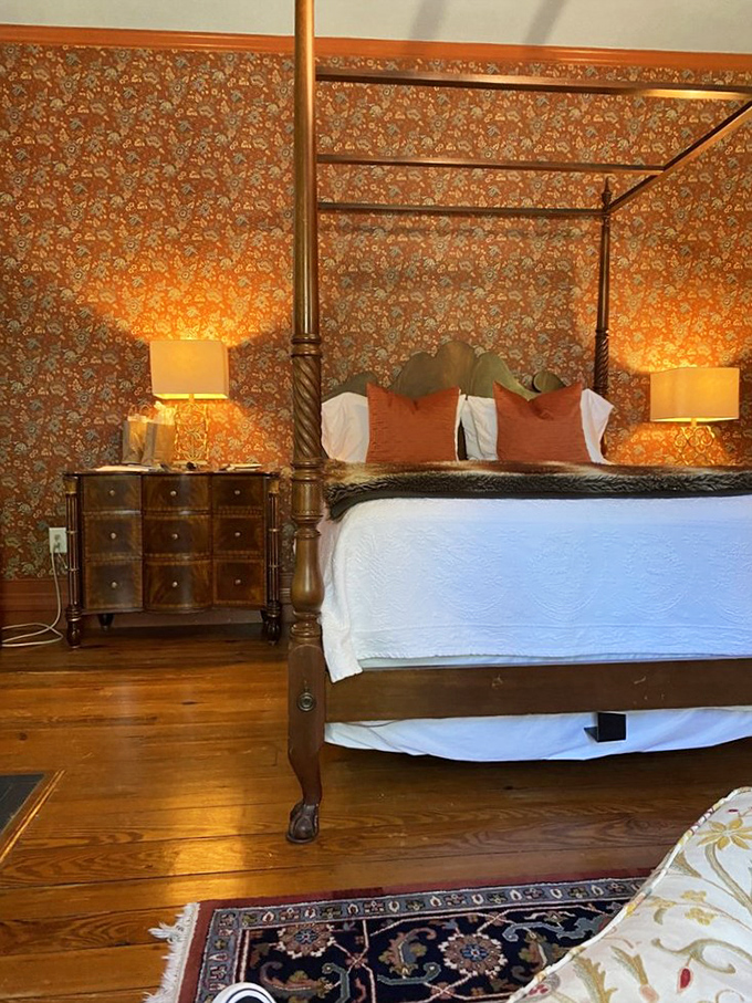 The rich floral wallpaper and four-poster bed create a cocoon of warmth in this guest room&mdash;like sleeping in a Jane Austen novel, but with better amenities.
