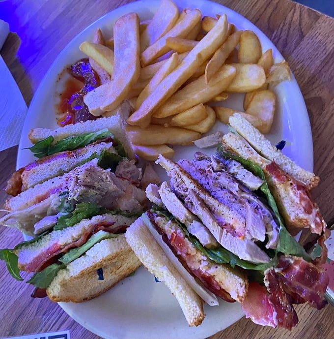 The club sandwich&mdash;mankind's greatest architectural achievement involving bread. This triple-decker beauty comes with a side of golden fries that demand attention.