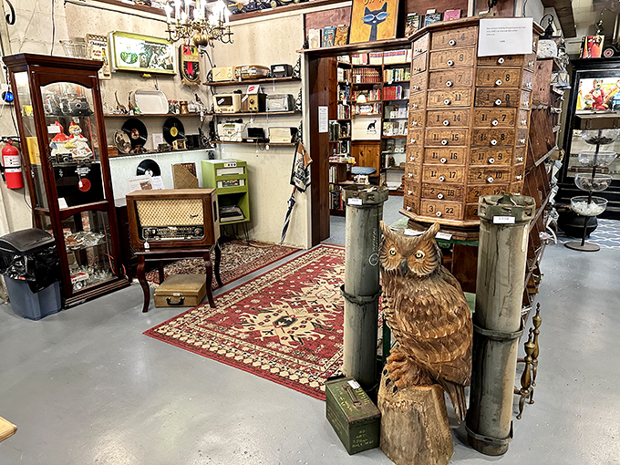 That carved wooden owl stands sentinel among the vintage radio and multi-drawer cabinet&mdash;guardians of someone's forgotten memories now awaiting rediscovery.