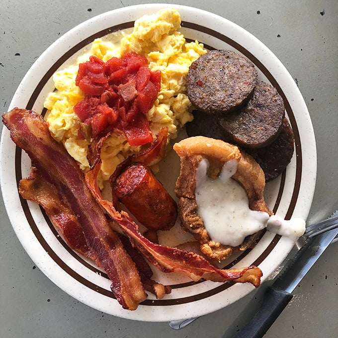 The holy trinity of breakfast: farm-fresh eggs, ham with just the right salt-to-sweet ratio, and a biscuit that deserves its own fan club.