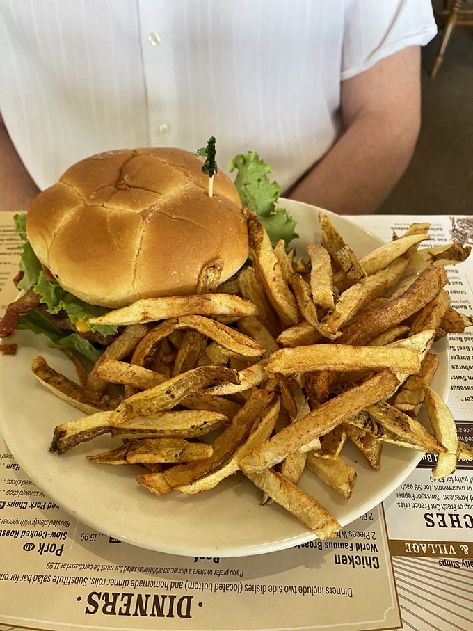 The humble burger gets the royal treatment here—hand-cut fries so plentiful they're practically staging a rebellion against the plate's boundaries.