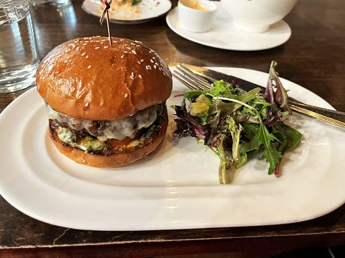 This isn't just a burger&mdash;it's a commitment. Juicy, perfectly stacked, and served with greens that somehow make you feel virtuous about your indulgence.