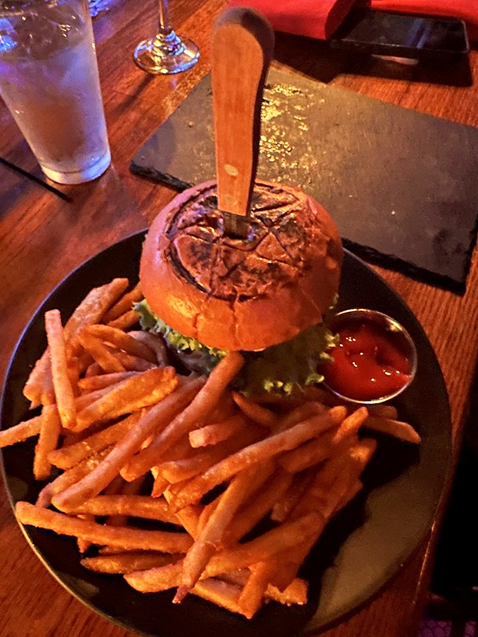 The Raven Burger arrives with a knife through its heart&mdash;dramatic presentation that matches the bold flavors lurking beneath that branded bun.