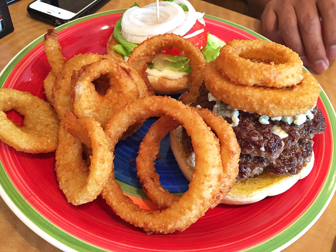 This isn't just a burger&mdash;it's a fortress surrounded by a moat of golden onion rings. Your diet plan's arch-nemesis has never looked so magnificent.