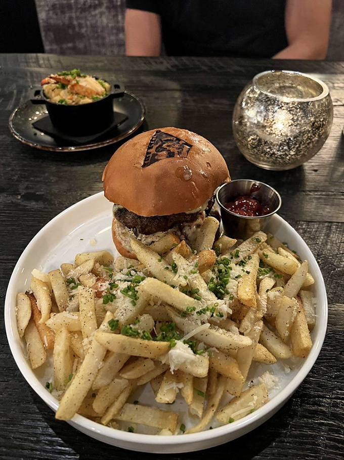 Burgers often live in steaks' shadow, but not this beauty. Perched proudly atop a mountain of fries, it's the overachiever of the sandwich world.