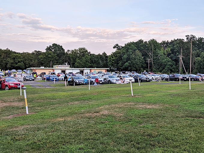 Nature provides the ceiling, cars become living rooms, and strangers become neighbors in this communal cathedral of cinema under Maryland stars.