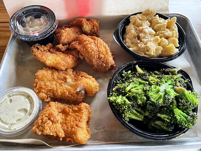 Golden-fried catfish that shatters with each bite, paired with sides that would make any Southern grandmother nod in silent approval.