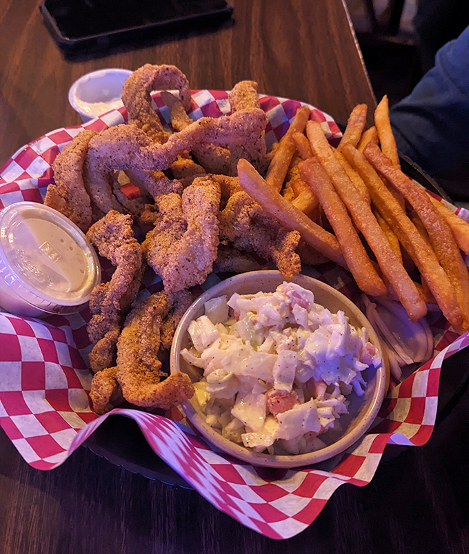 Cornmeal-crusted catfish strips arranged like a delicious game of pick-up sticks, ready to be dunked in that creamy sauce.
