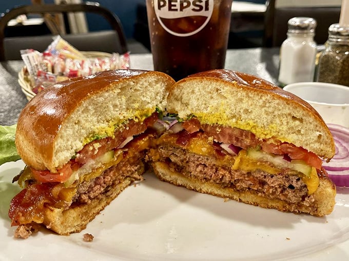 The cross-section of this burger reveals the architectural genius behind comfort food—layers of flavor stacked with the precision of a delicious Jenga tower.