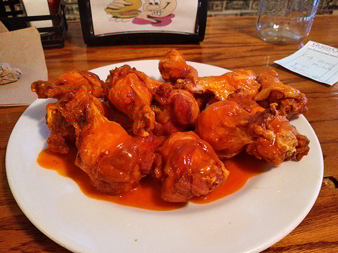 These buffalo wings aren't flying anywhere except straight to flavor town, glistening with sauce that promises a delicious mess.