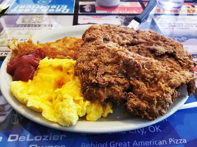 The chicken fried steak arrives like a crispy golden island in a sea of creamy gravy—a testament to Oklahoma's comfort food prowess.