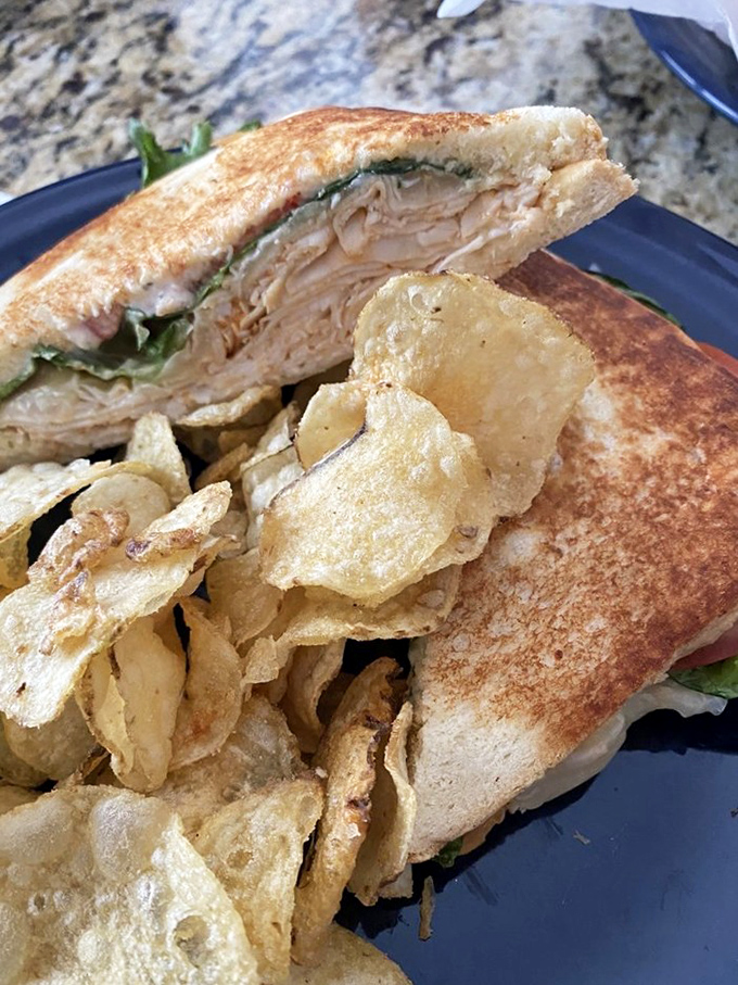 Golden-toasted bread hugging tender turkey with crisp lettuce&mdash;proof that simple ingredients in the right hands create edible poetry and potato chip joy.