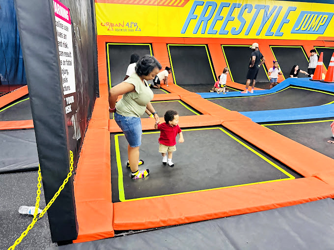 Tiny jumpers and their guardians experience the joy of synchronized bouncing. It's like a parent-child dance where gravity is merely a suggestion. 