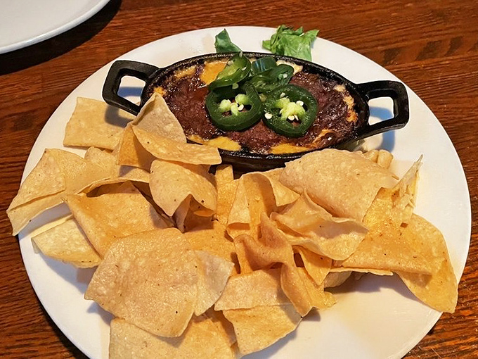 This isn't just any dip&mdash;it's a bubbling cauldron of cheesy goodness topped with jalape&ntilde;os, waiting to transform ordinary tortilla chips into vehicles of flavor.