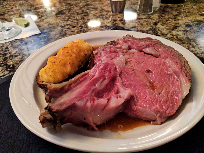 Fork-tender prime rib that requires minimal effort to devour, paired with a loaded baked potato that's practically a meal unto itself.