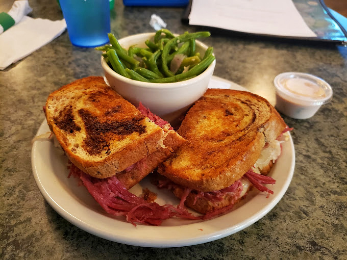 A proper corned beef sandwich that doesn't skimp on the meat. Those green beans aren't just a garnish&mdash;they're trying to convince you this meal has balance.