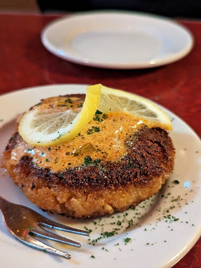 The crab cake that launched a thousand road trips. That perfect sear gives way to sweet crab meat that tastes like it just took a wrong turn at the Atlantic.