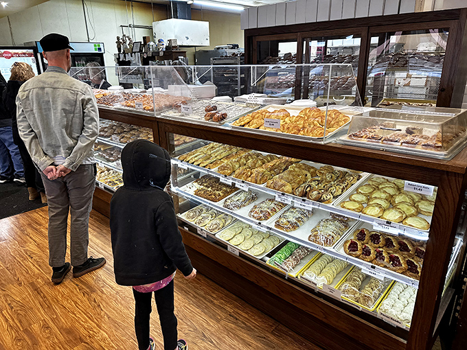 The universal language of anticipation: customers contemplating life's most important question &ndash; "How many donuts is too many donuts?"