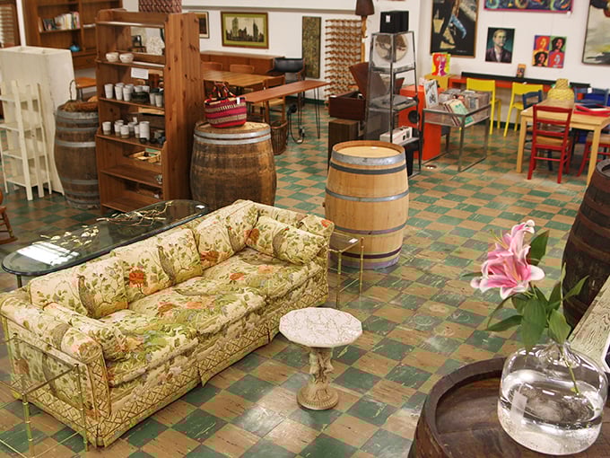 Wooden barrels and eclectic furniture create unexpected vignettes throughout the store, like film sets waiting for their starring actors.