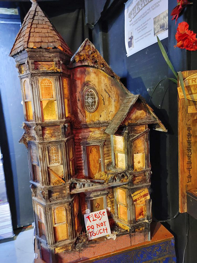 This haunted dollhouse comes with its own "Please Do Not Touch" warning. Some architectural nightmares are best admired from a distance.