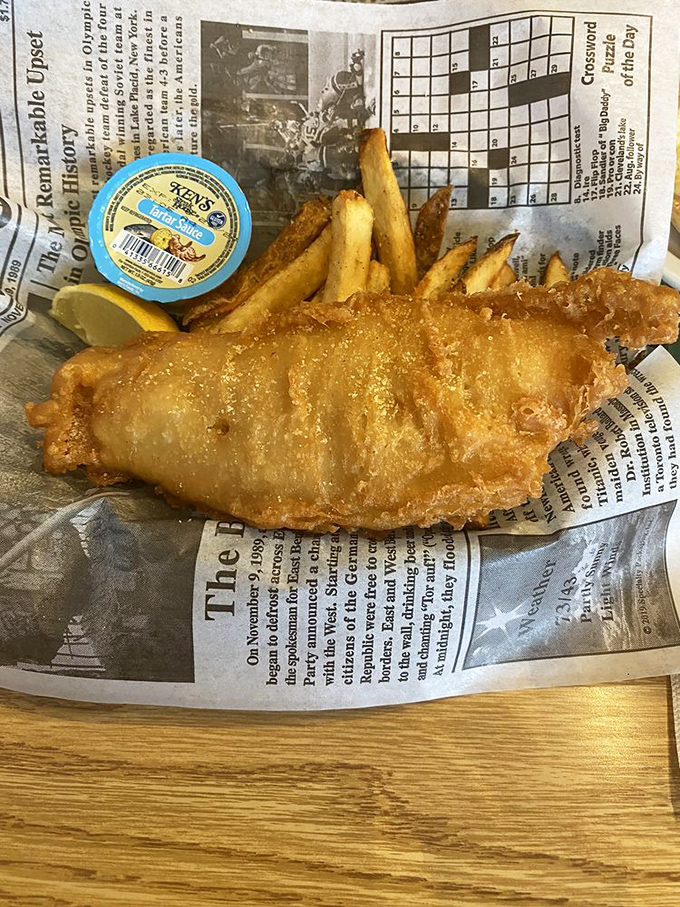 Fish and chips done proper Aussie-style, wrapped in newspaper like a delicious present. That golden batter is crunchier than my retirement portfolio.