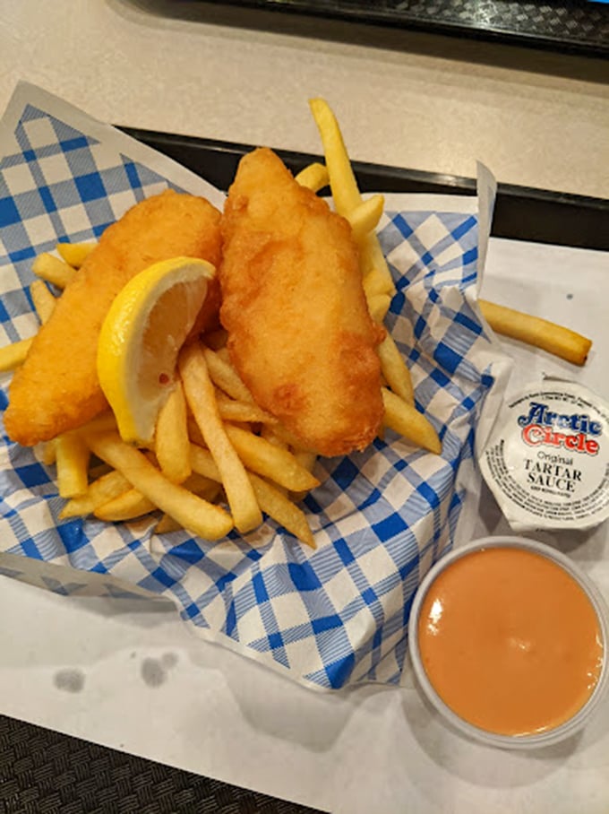 Golden-battered fish nestled among crispy fries, with that signature fry sauce standing by like a peachy-pink wingman ready for action.