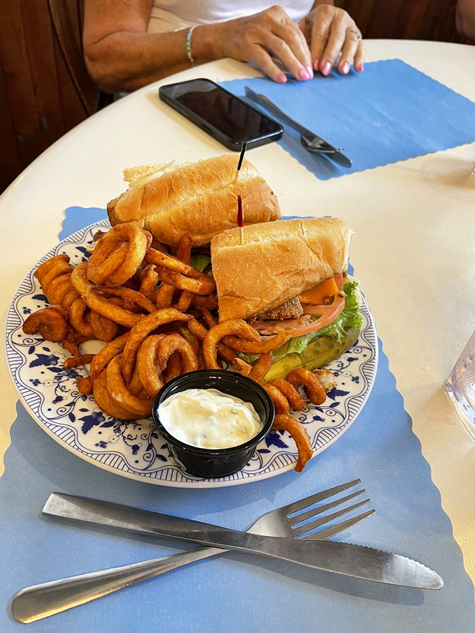 Comfort food done right&mdash;a sandwich that requires both hands and several napkins. Those curly fries are calling your name too.