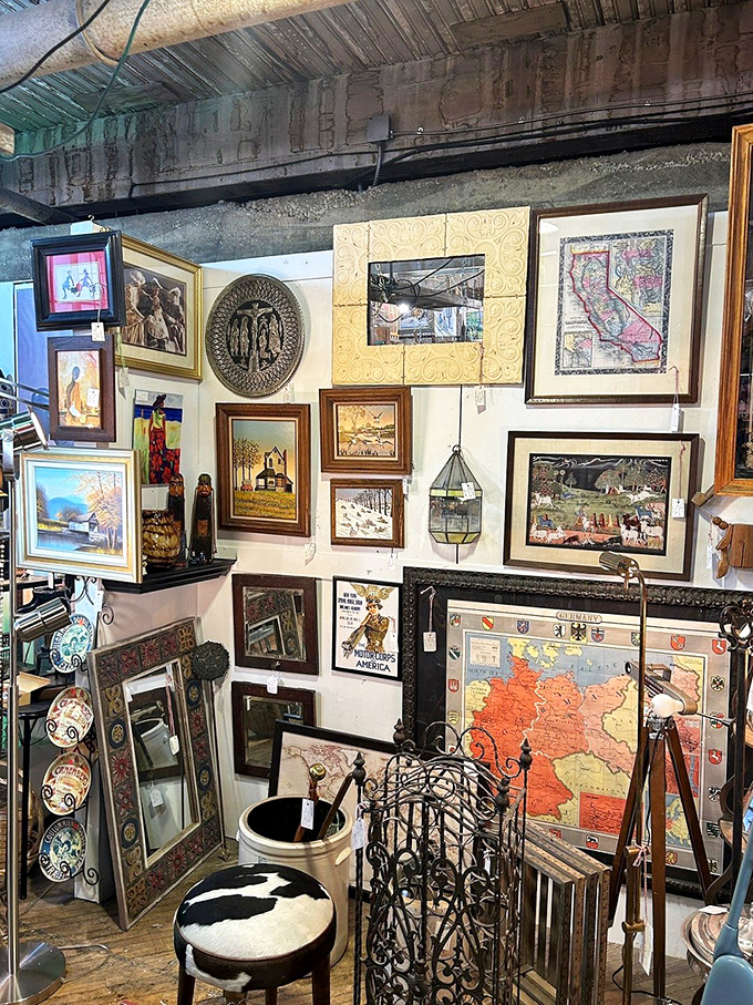 A gallery wall that would make Instagram influencers weep with envy, featuring everything from antique maps to vintage advertisements.